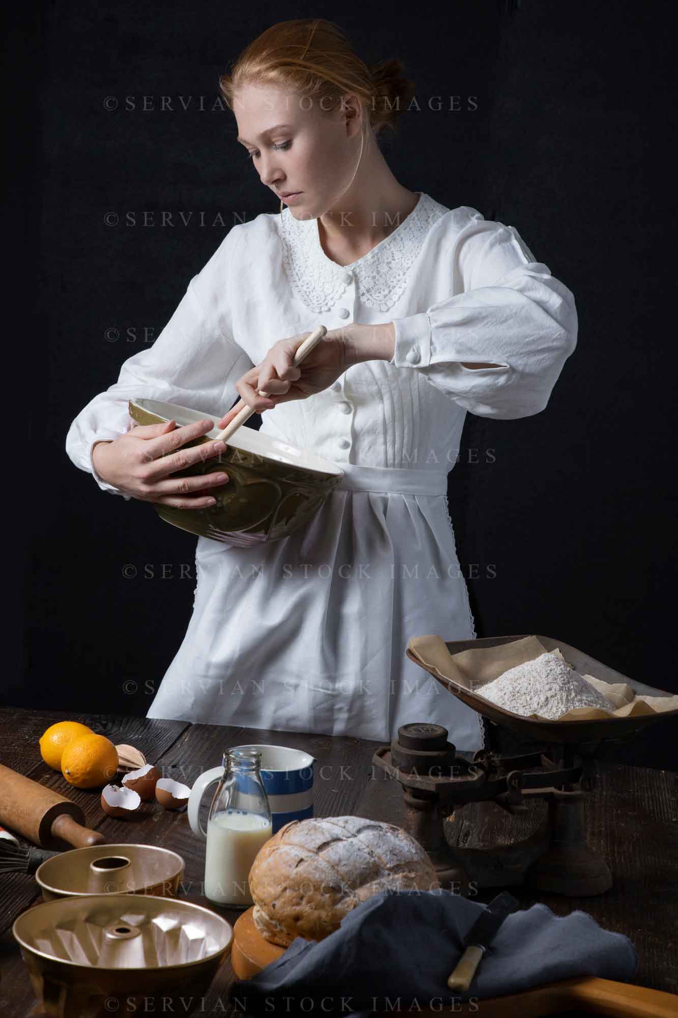 Victorian woman baking in her kitchen (Lauren 2697) – Servian Stock Images