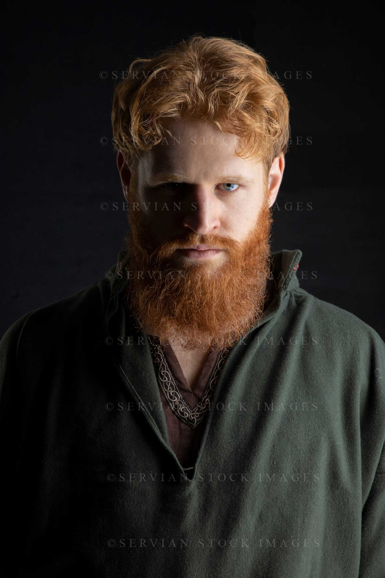 Viking or high fantasy man with red hair and beard against a black bac ...